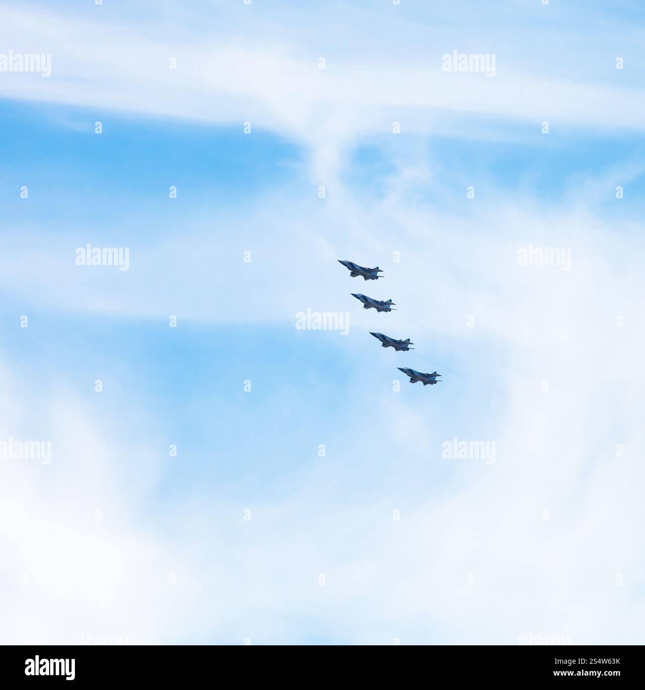 four military fighter jets in cloudy blue sky Stock Photo - Alamy