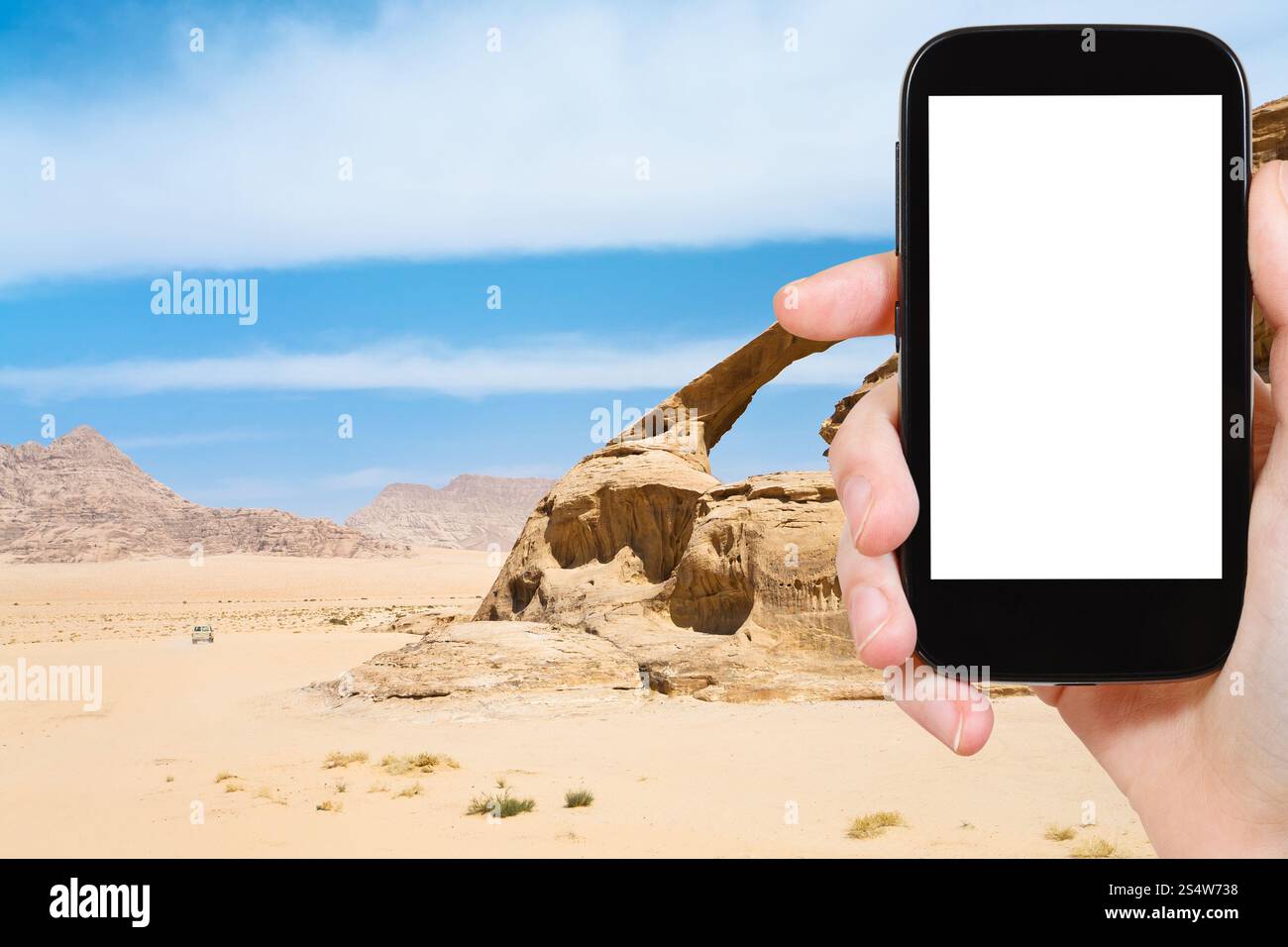 travel concept - tourist photograph Bridge rock in Wadi Rum desert ...