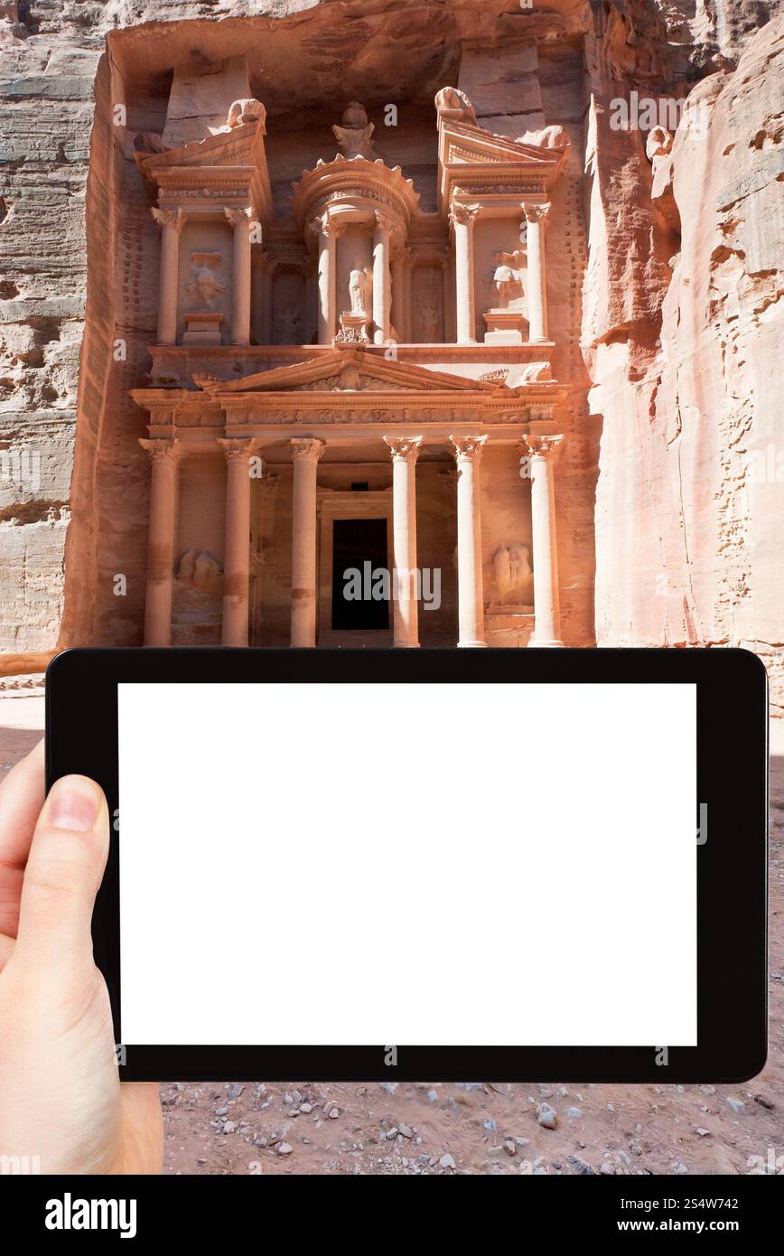 travel concept - tourist photograph temple in ancient town Petra ...