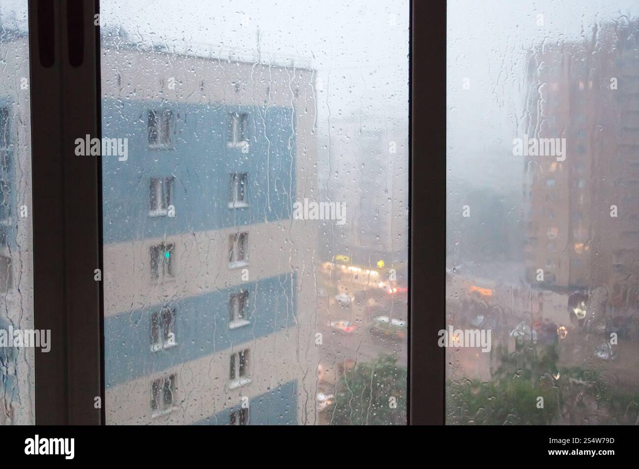 rain running down window panes at home in spring twilight Stock Photo ...