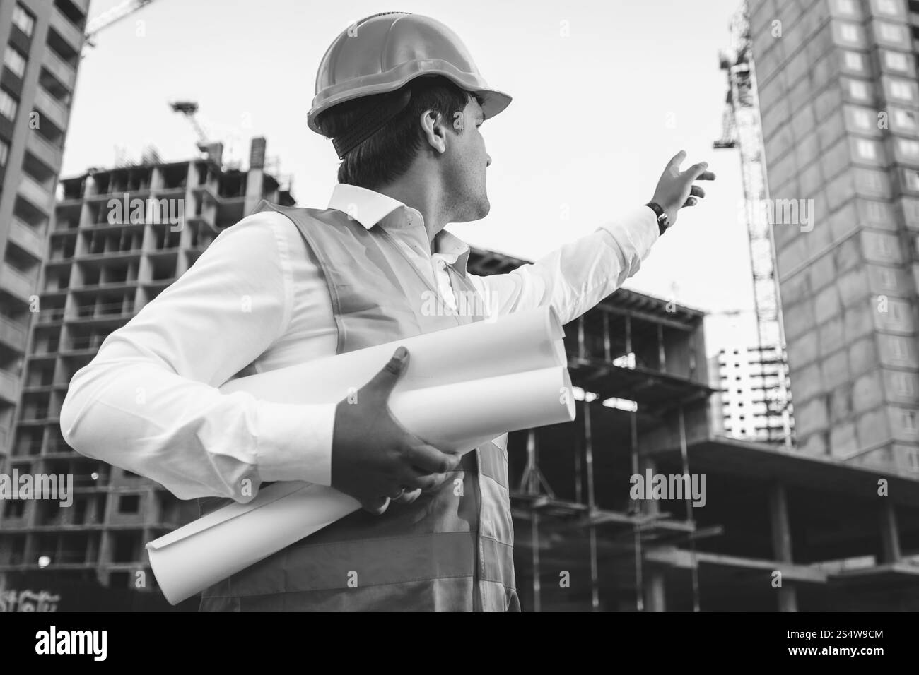 Construction manager controlling building Black and White Stock Photos ...