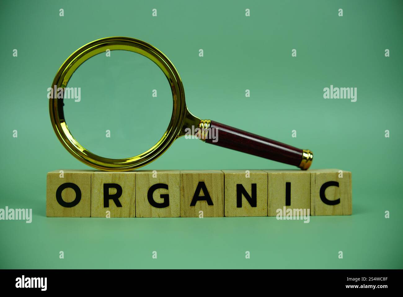 Organic with wooden blocks alphabet letters and magnifying glass on ...