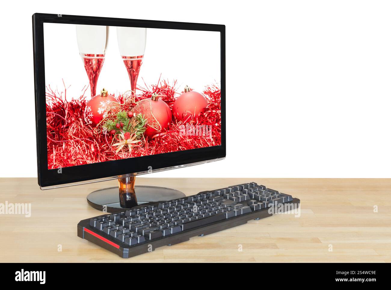 Christmas still life with red baubles and glasses on screen of desktop ...