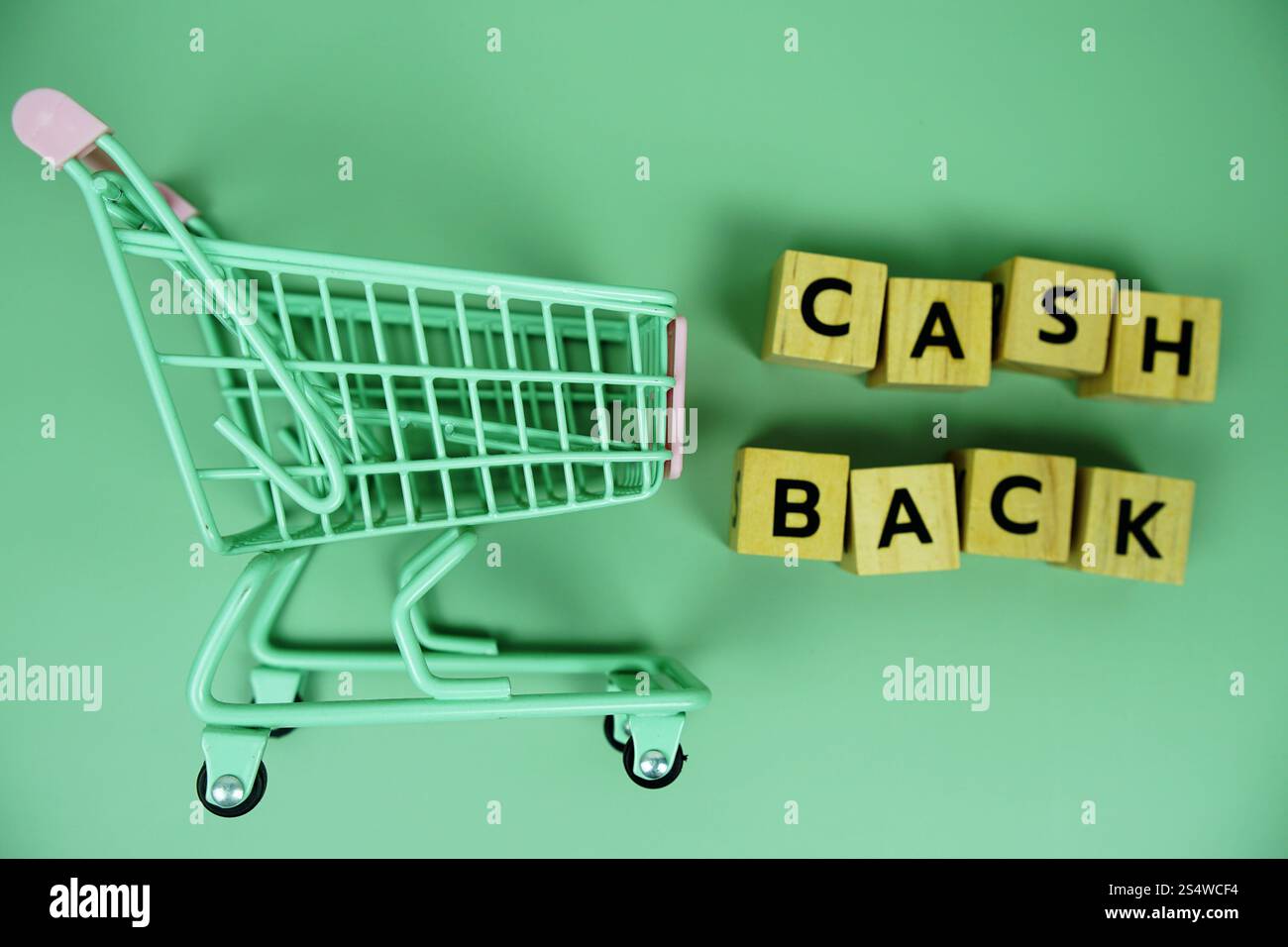 Cashback with wooden blocks alphabet letters and mini trolley shopping ...
