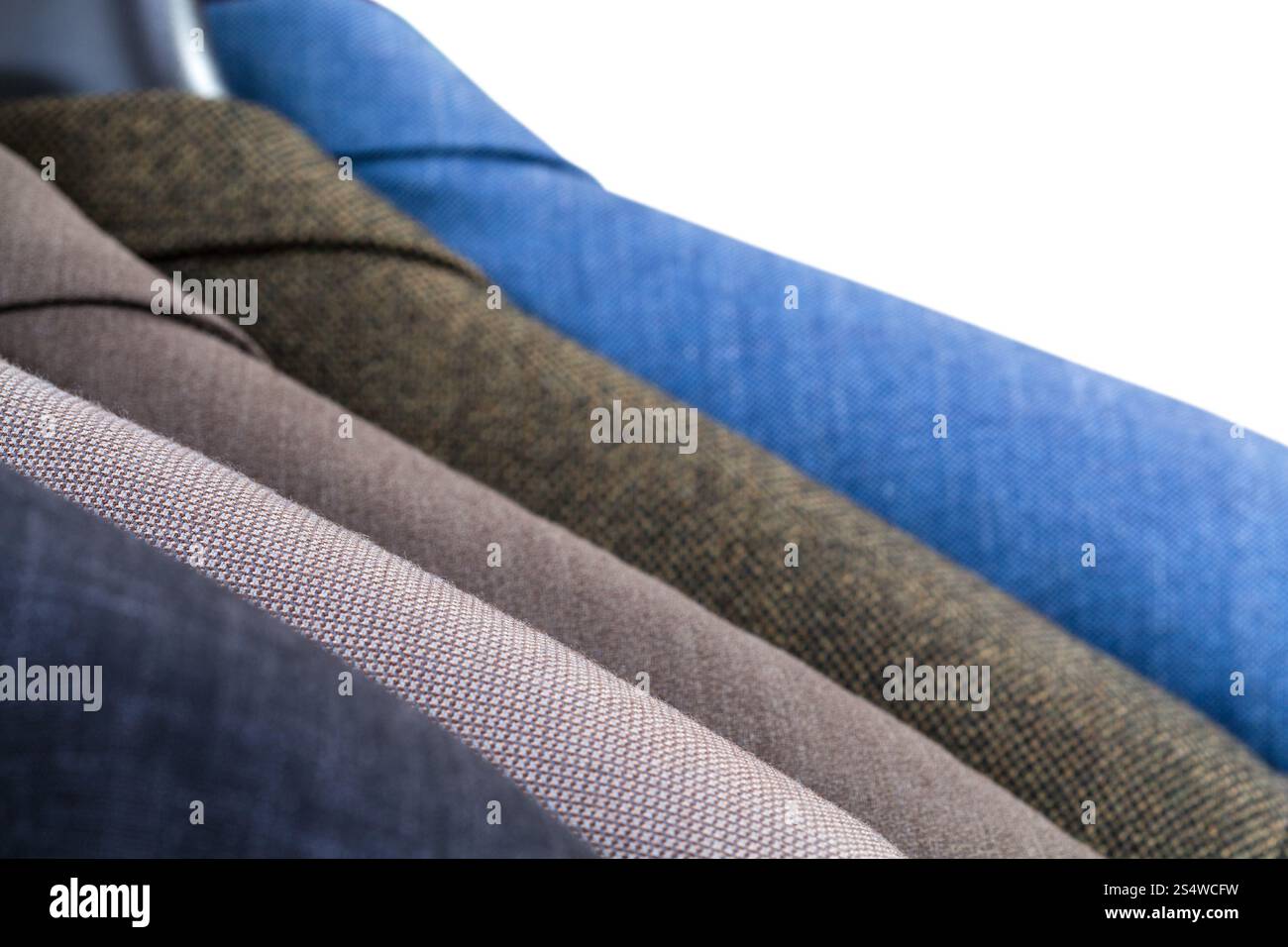 finished jackets on hangers in tailoring atelier close up isolated on ...