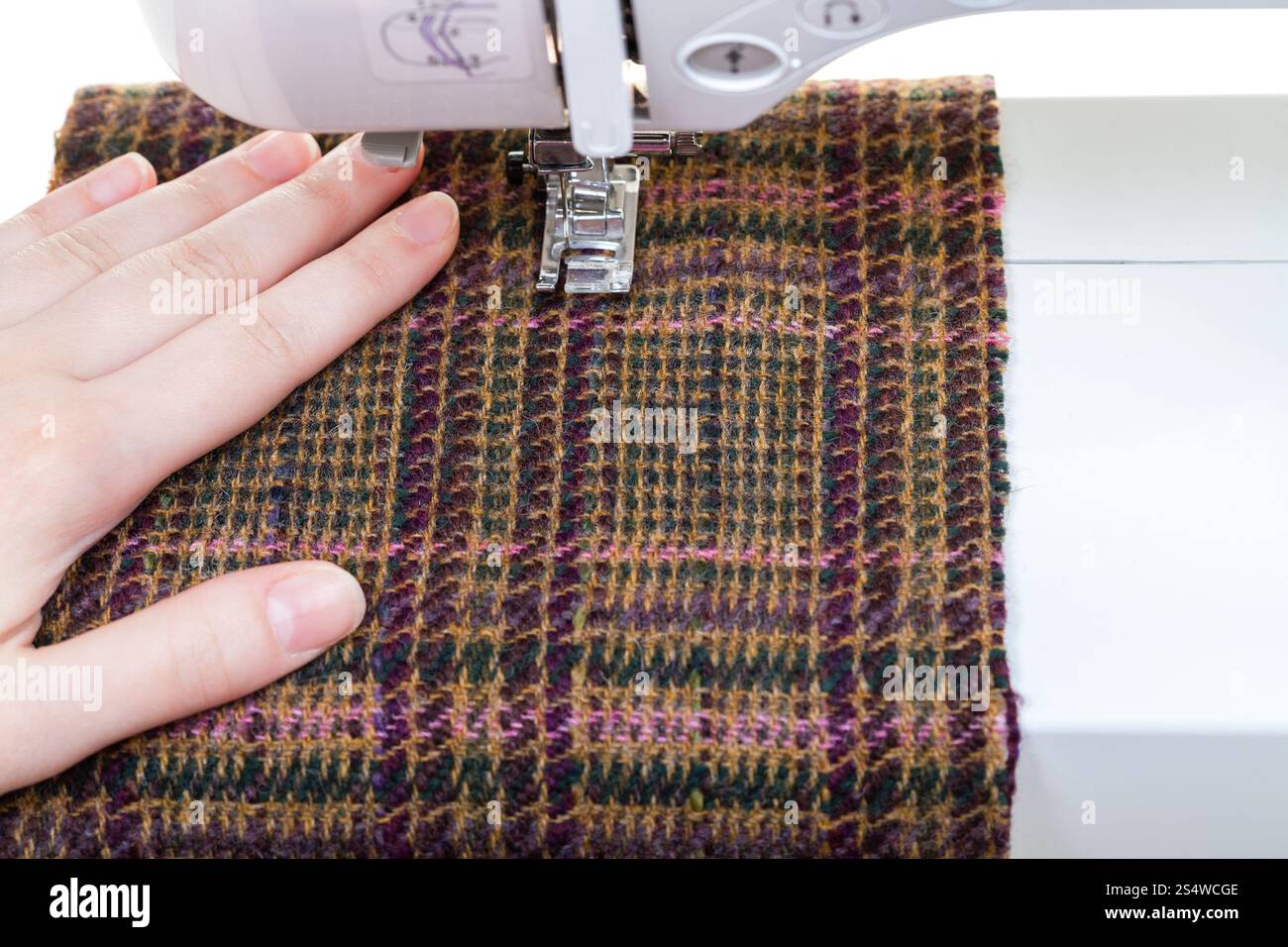 sewer hand and foot of sewing machine on woolen textile close up Stock ...