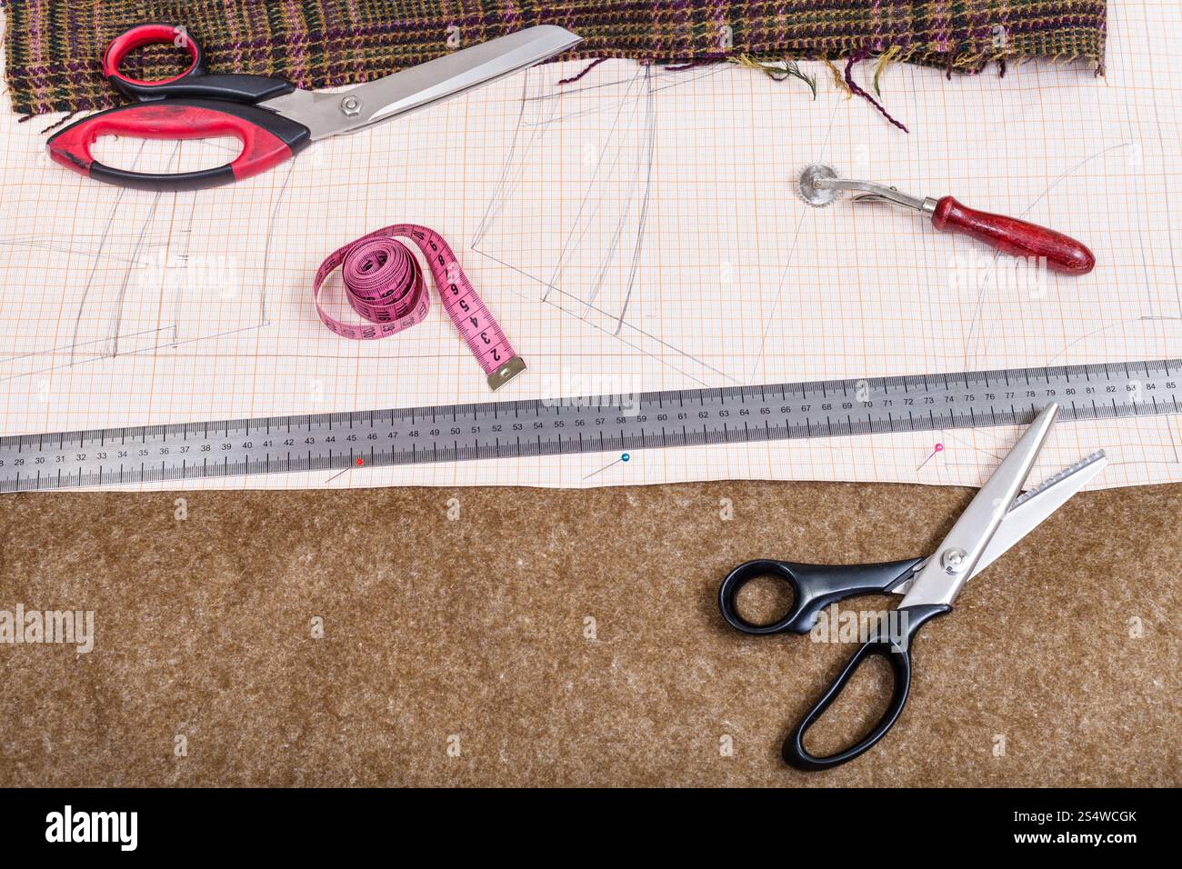 dressmaking still life - top view of cutting table with tissue, pattern ...