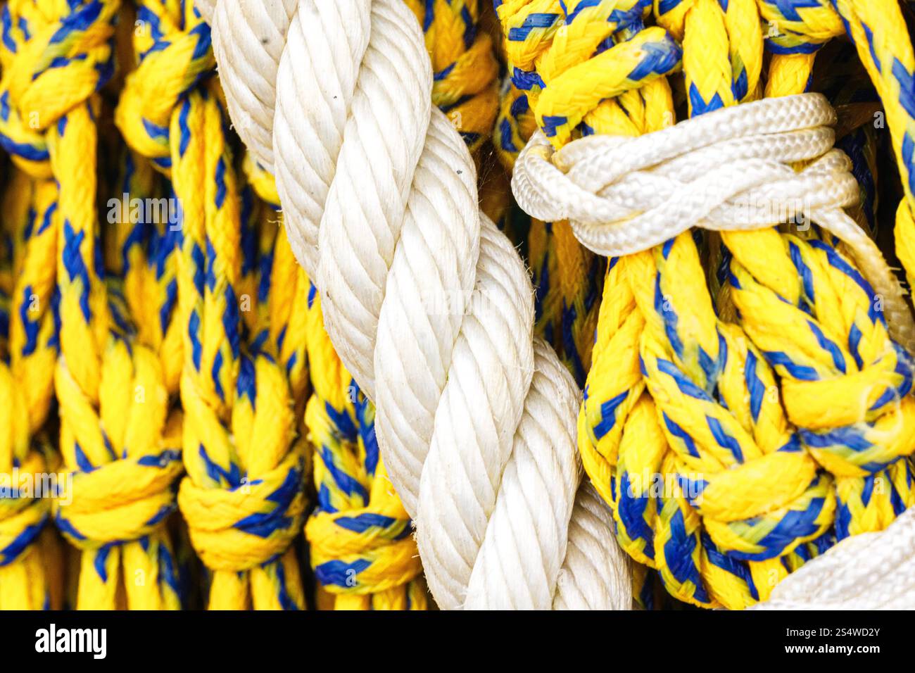 Close-up view of a traditional fishing net made of yellow and blue ...