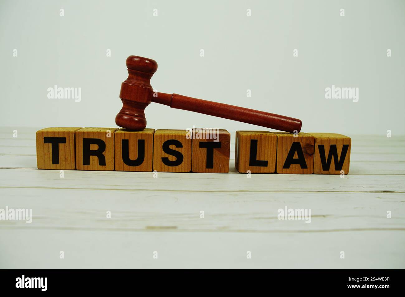 Trust Law with wooden blocks alphabet letters and magnifying glass on ...