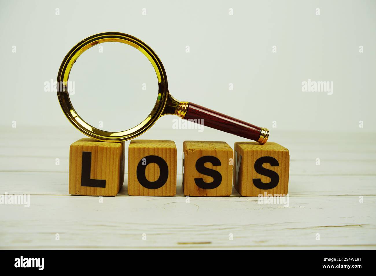 Loss alphabet letters with magnifying glass on wooden background Stock ...
