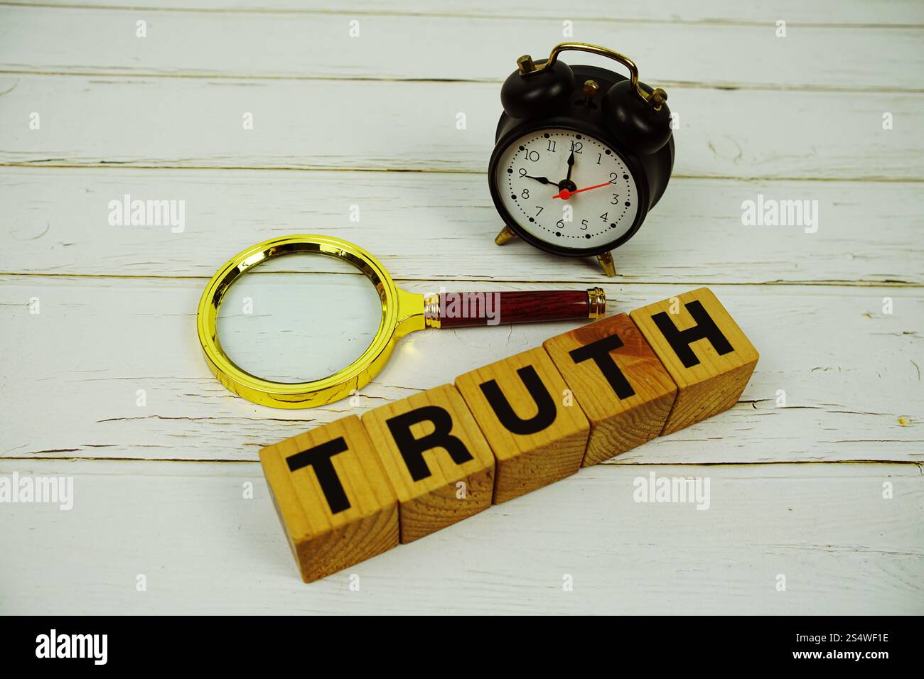 Truth alphabet letters with magnifying glass and alarm clcok top view ...