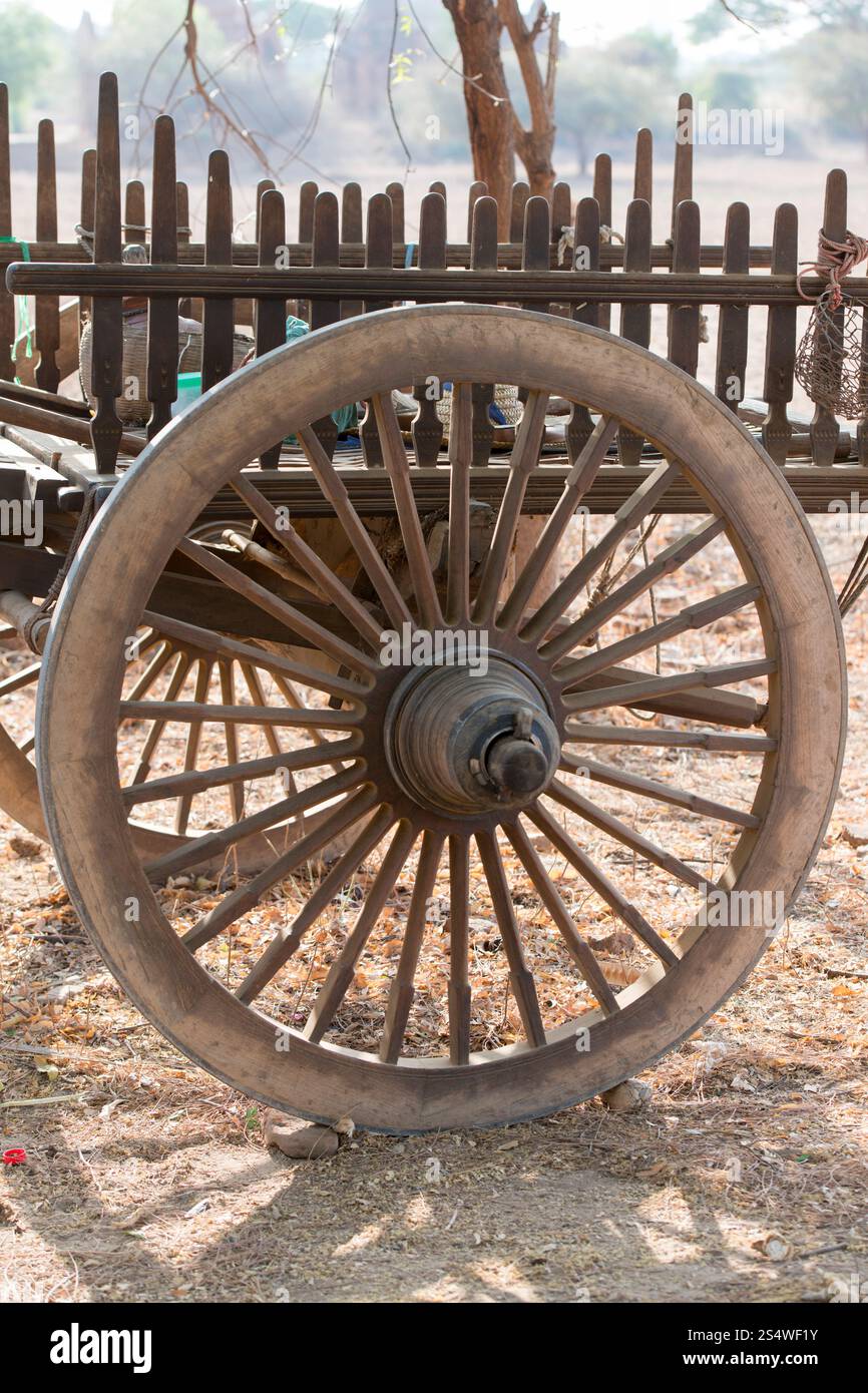 a wheel of a woodcart of a farmer stays on a field in Bagan in Myanmar ...