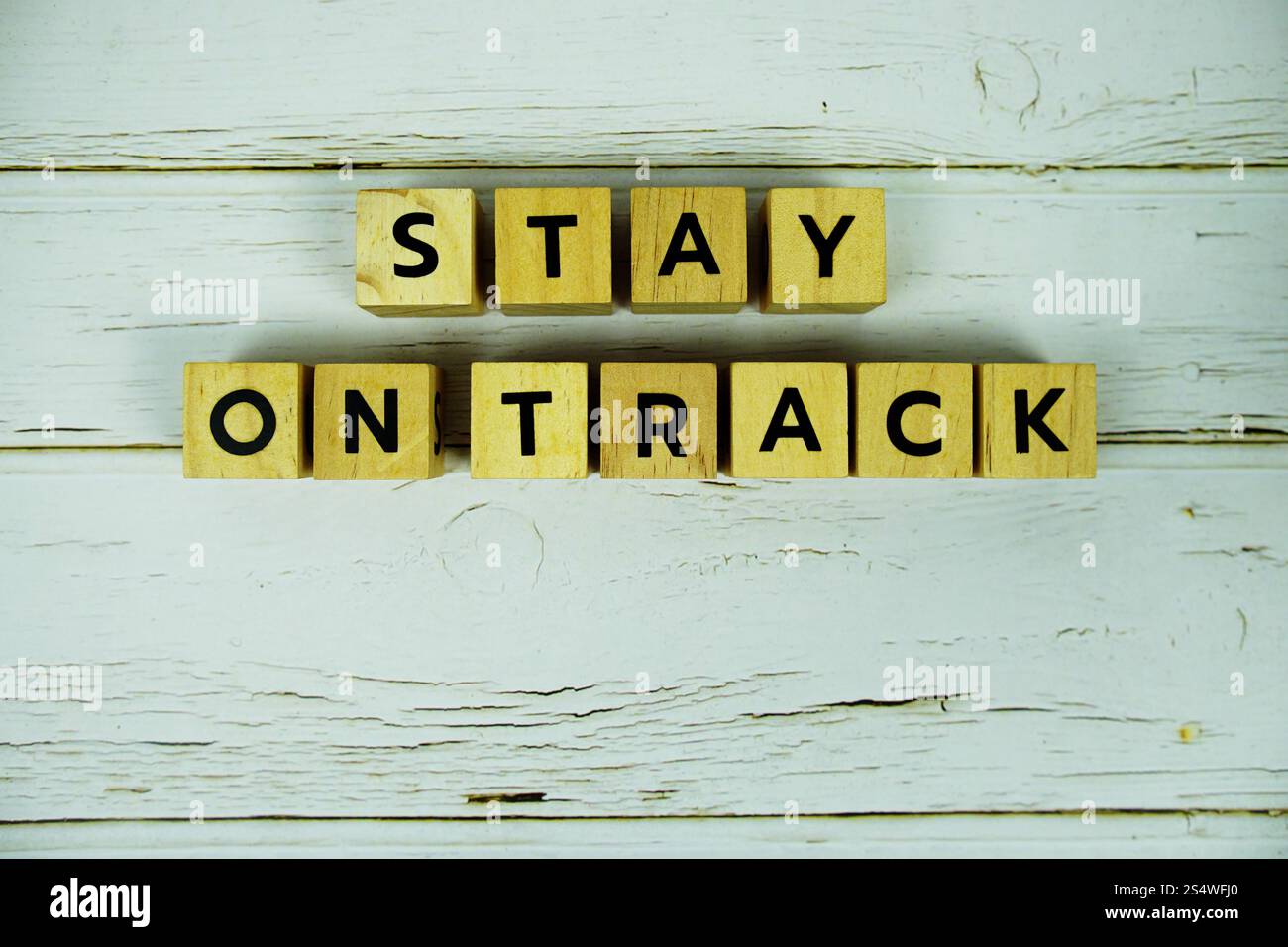 Stay on Track with wooden blocks alphabet letters on wooden background ...