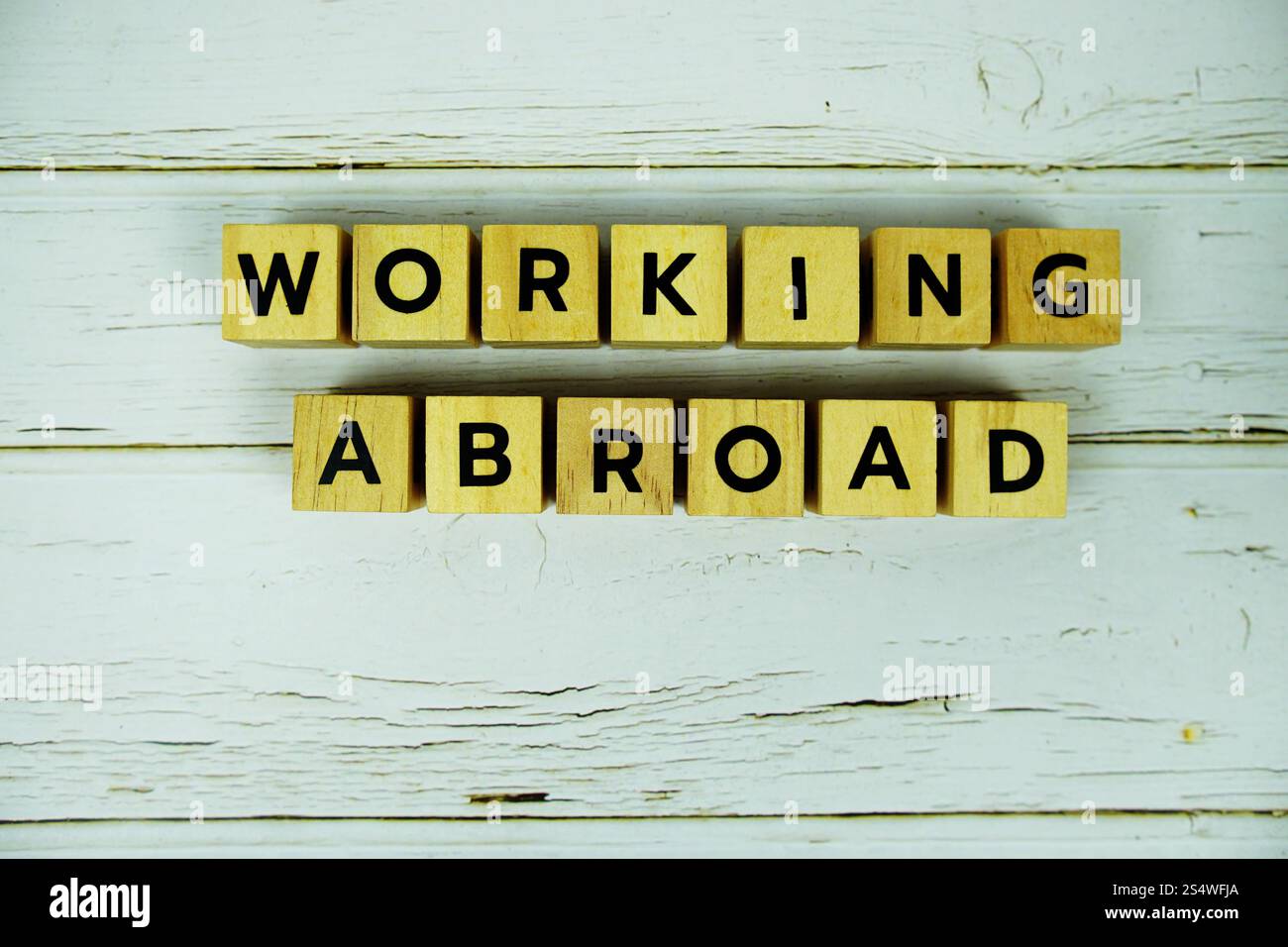 Working Abroad with wooden blocks alphabet letters on wooden background ... Working Abroad with wooden blocks alphabet letters on wooden background ...