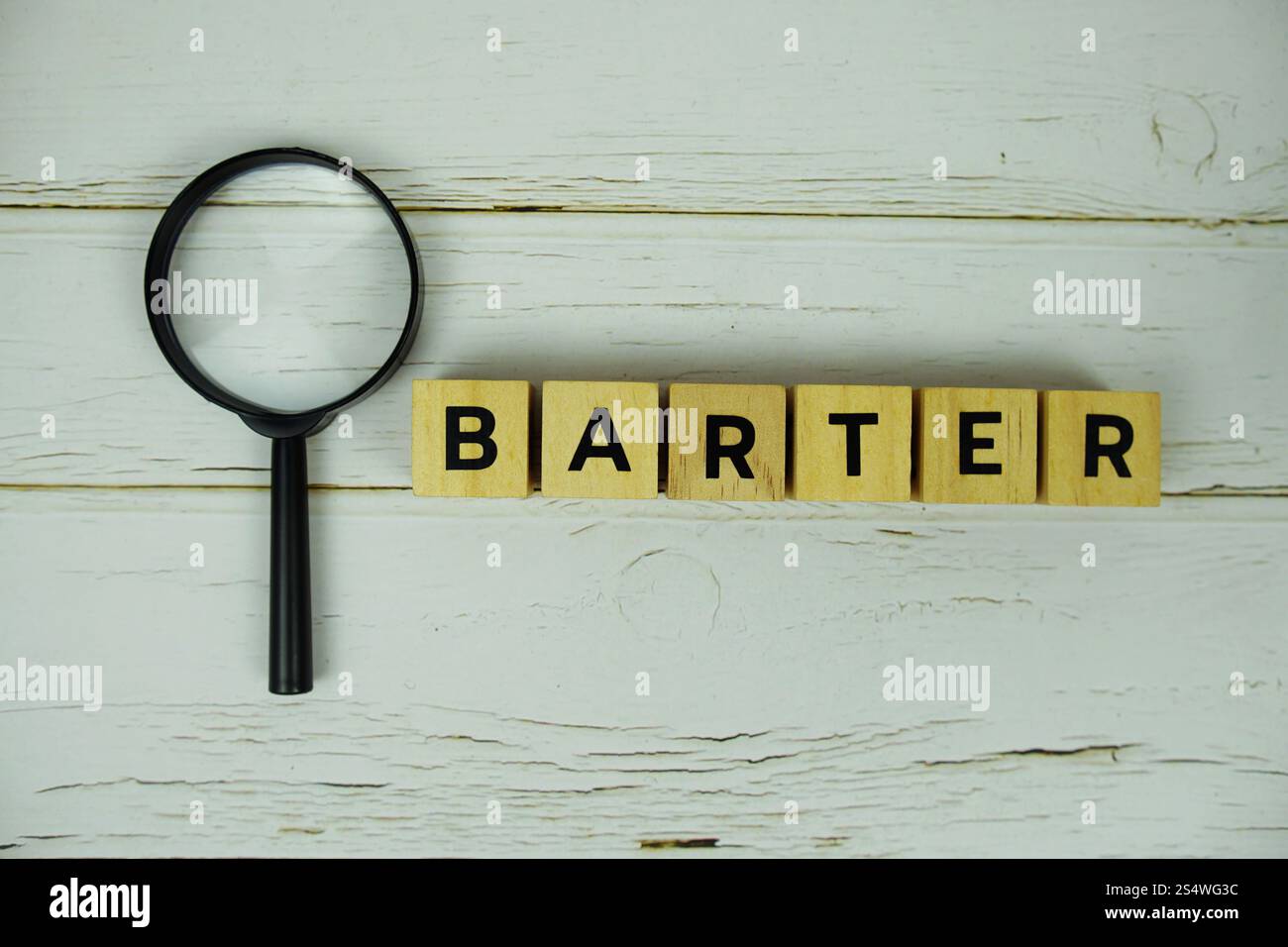 Barter with wooden blocks alphabet letters and magnifying glass on ...