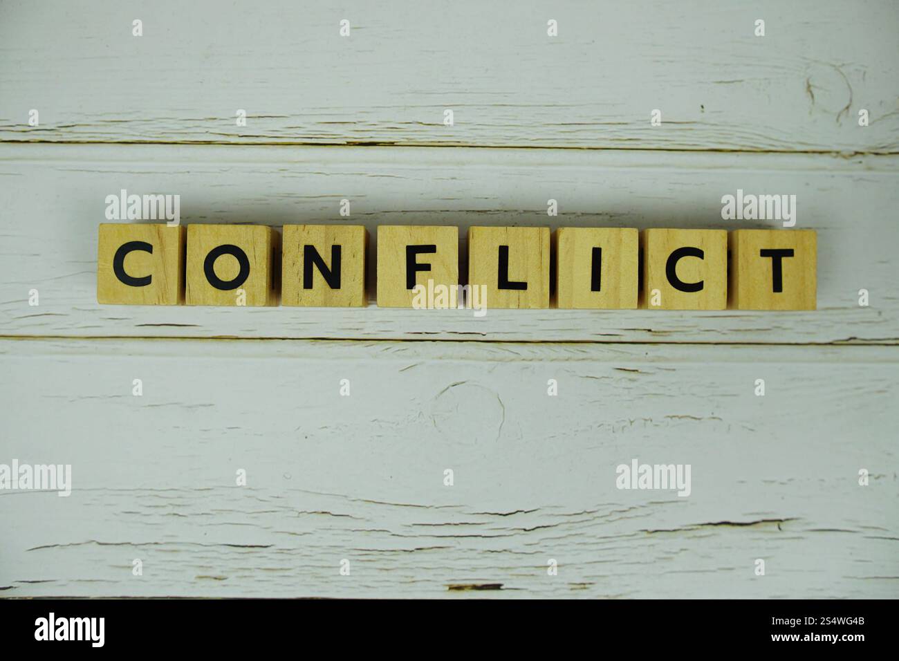 Conflict with wooden blocks alphabet letters on wooden background Stock ...