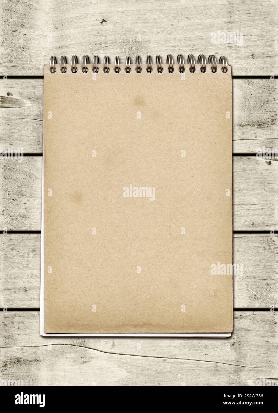 Closed spiral Note book on a white wood table. Mockup. Closed spiral ...