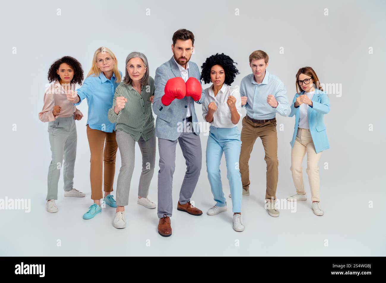 Diverse group of business professionals in formal attire posing ...