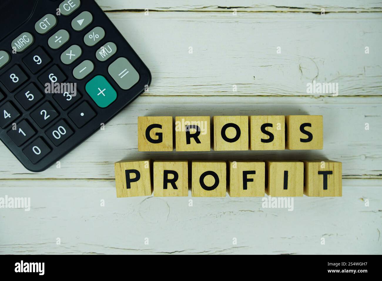 Gross Profit with wooden blocks alphabet letters and calculator on ...