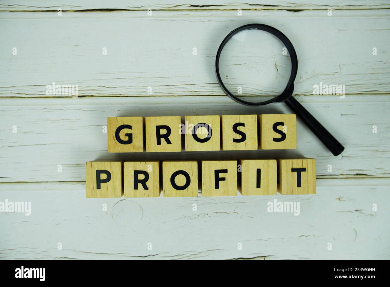 Gross Profit with wooden blocks alphabet letters and magnifying glass ...