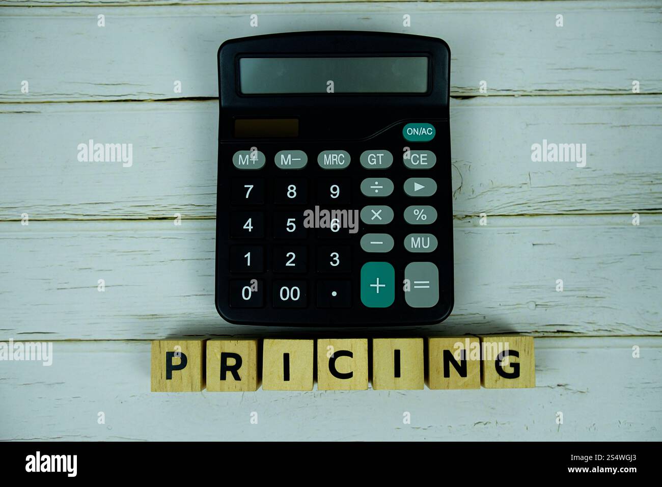 Pricing with wooden blocks alphabet letters and calculator on wooden ...