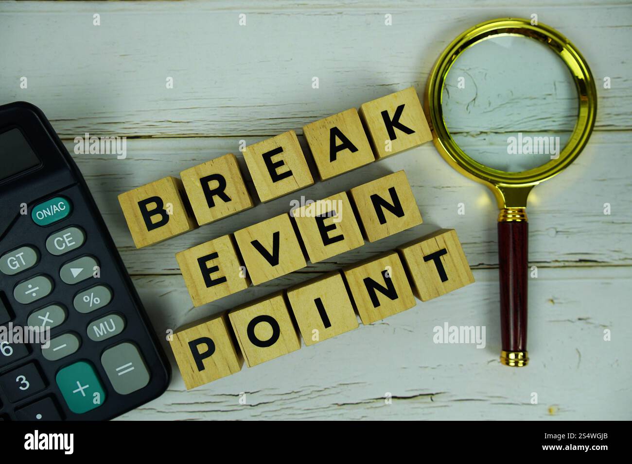 Break Even Point with wooden blocks alphabet letters and magnifying ...