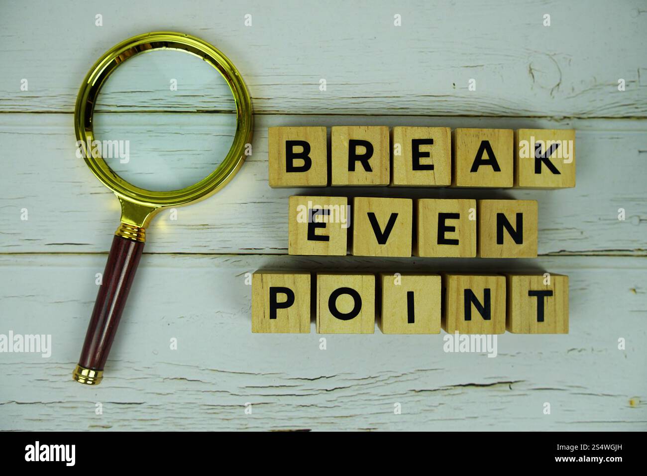 Break Even Point with wooden blocks alphabet letters and magnifying ...