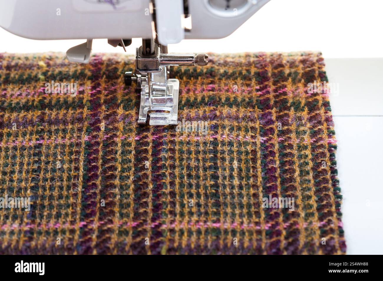 foot of sewing machine on woolen textile close up Stock Photo - Alamy