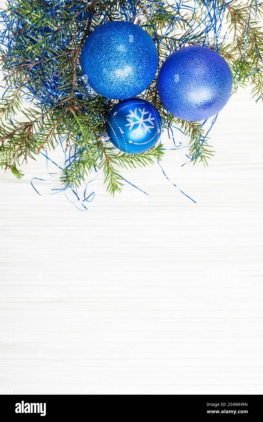 Christmas greeting card - border from three blue Xmas baubles and tree ...