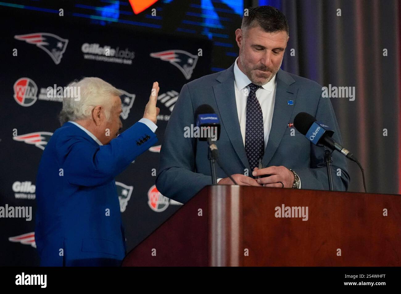 New England Patriots head coach Mike Vrabel, right, gets a pat on the ...
