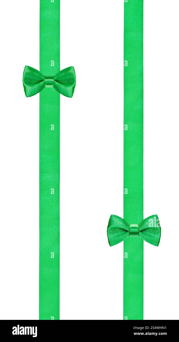 two little green bow knots on two parallel satin ribbons isolated on ...