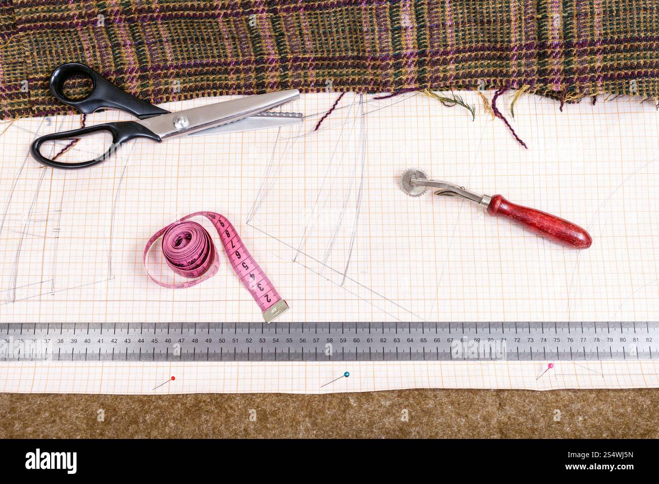 dressmaking still life - top view of cutting table with cloth, pattern ...