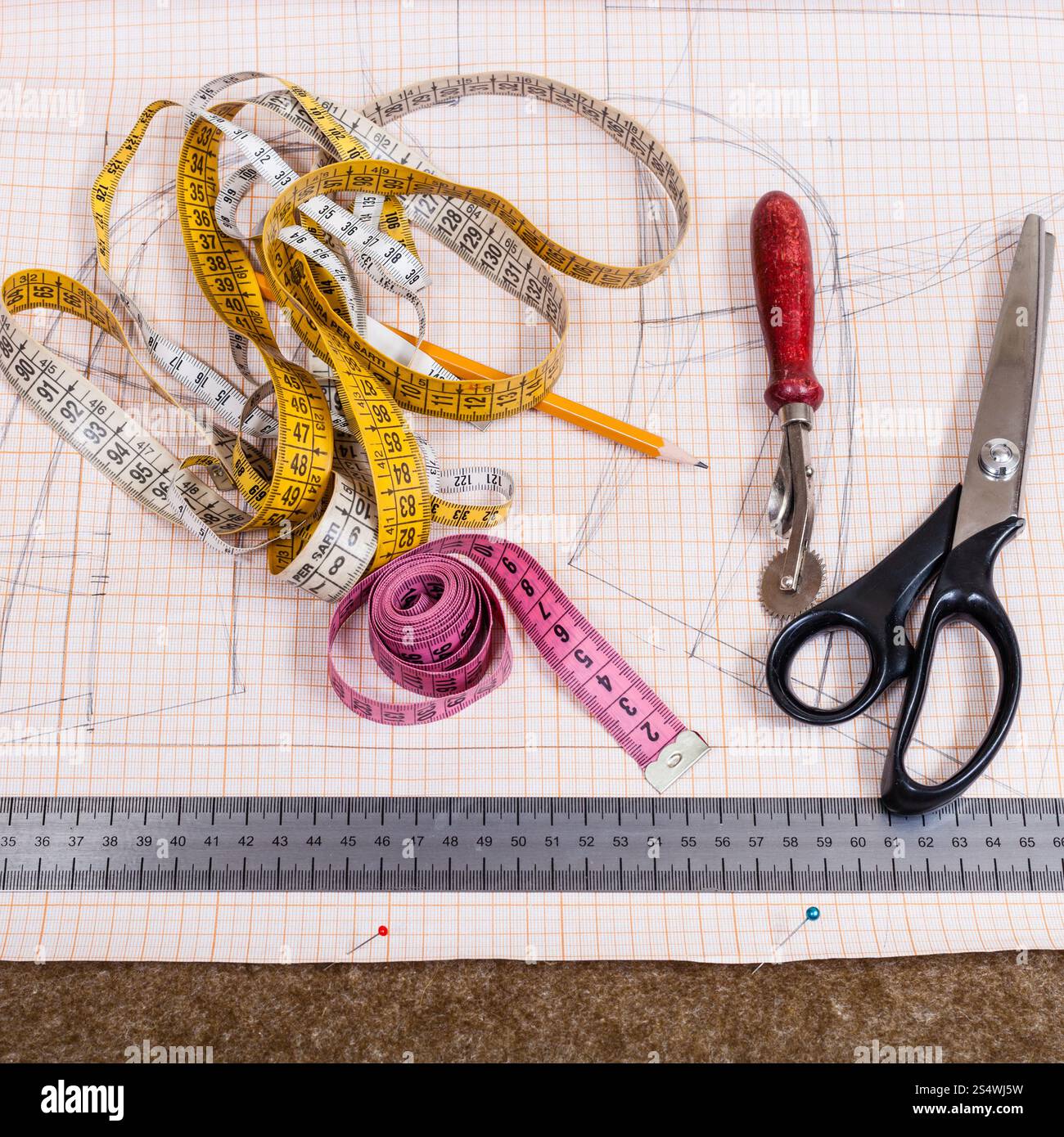 dressmaking still life - top view of cutting table with cloth, pen ...