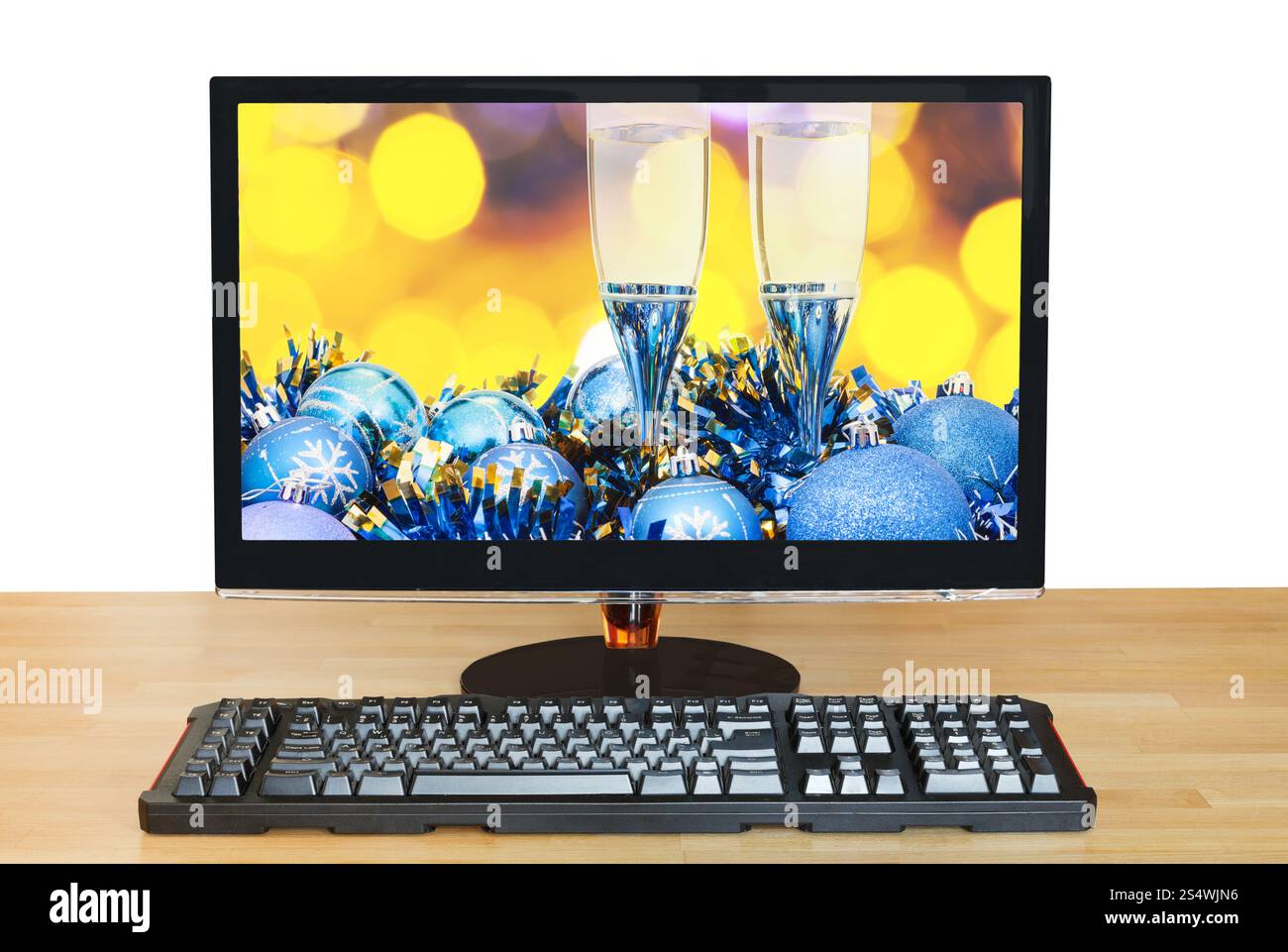 Christmas still life with glasses and blue baubles on screen of monitor ...