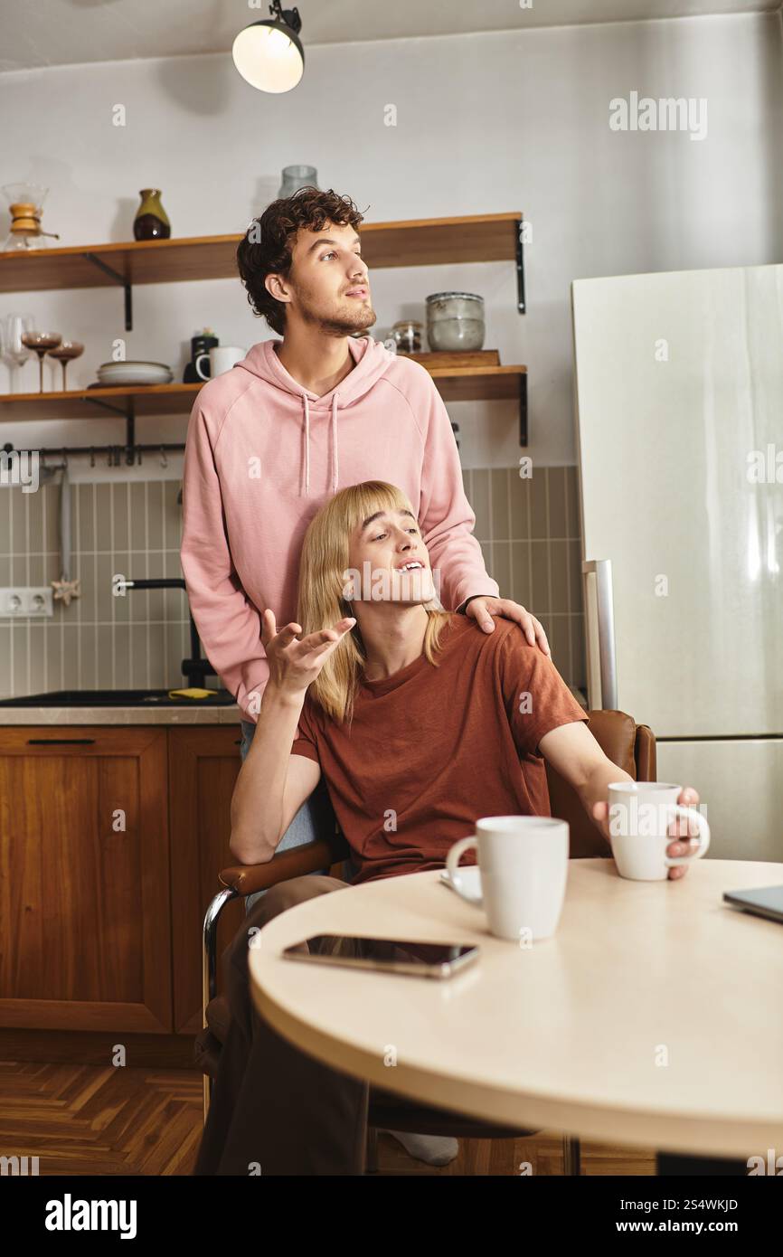 Two men enjoy a loving moment in their cozy, modern kitchen Stock Photo ...
