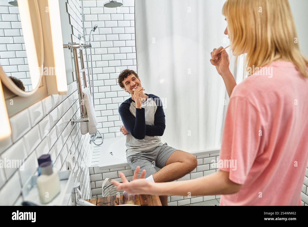 Two men share a playful conversation during a relaxing moment in their ...