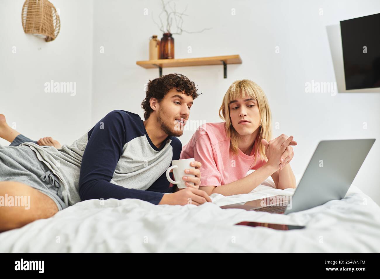 Two men share a relaxed evening together, smiling and interacting while ...