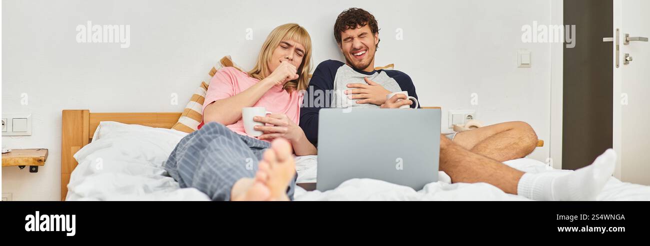 Two men cuddle on a cozy bed while enjoying a fun movie night with ...