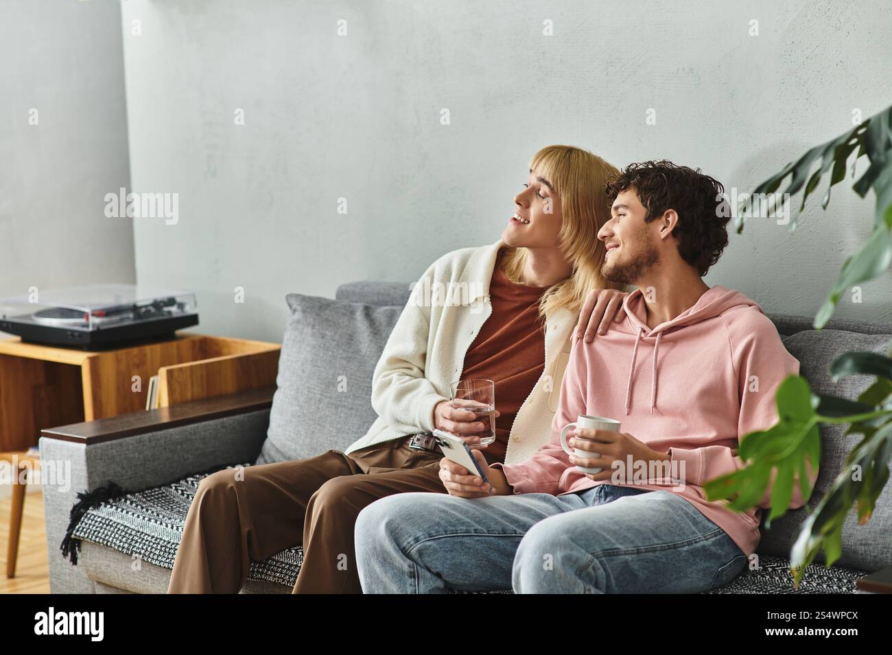 Two men share a heartfelt moment in a comfortable living room, enjoying ...