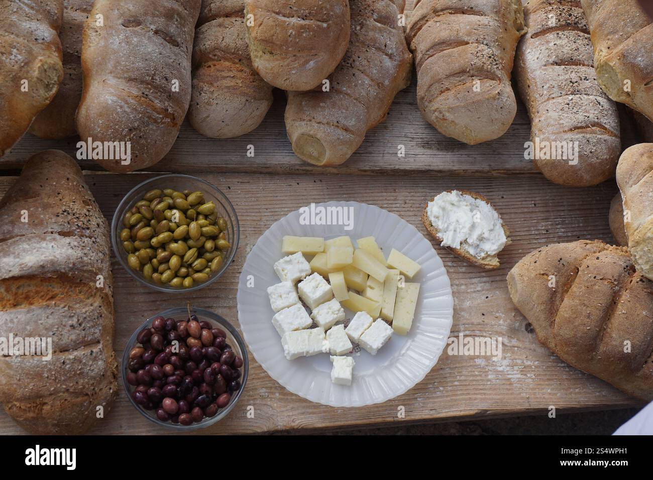 Traditional handmade loaves of sourdough bread with green and black ...