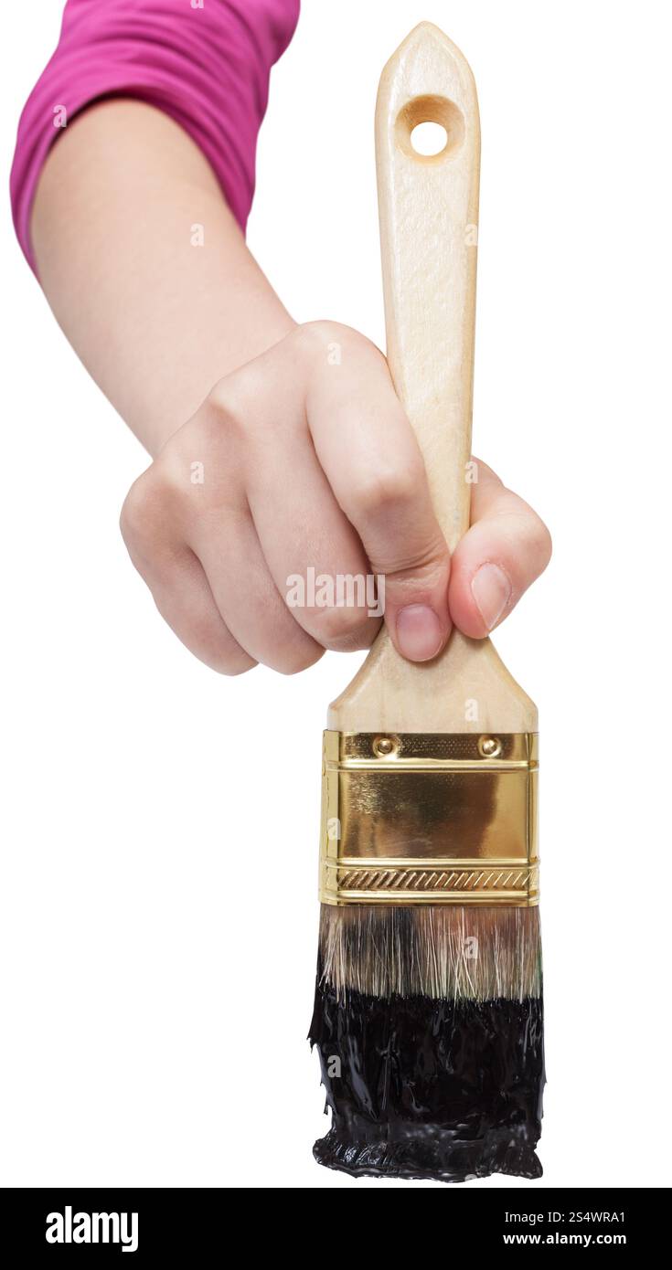 direct view of painter hand with flat paintbrush painting in black ...
