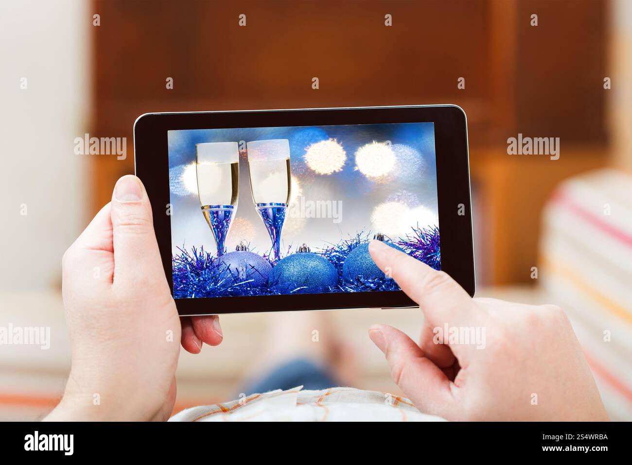 Christmas concept - man in living room touches screen of tablet-pc with ...