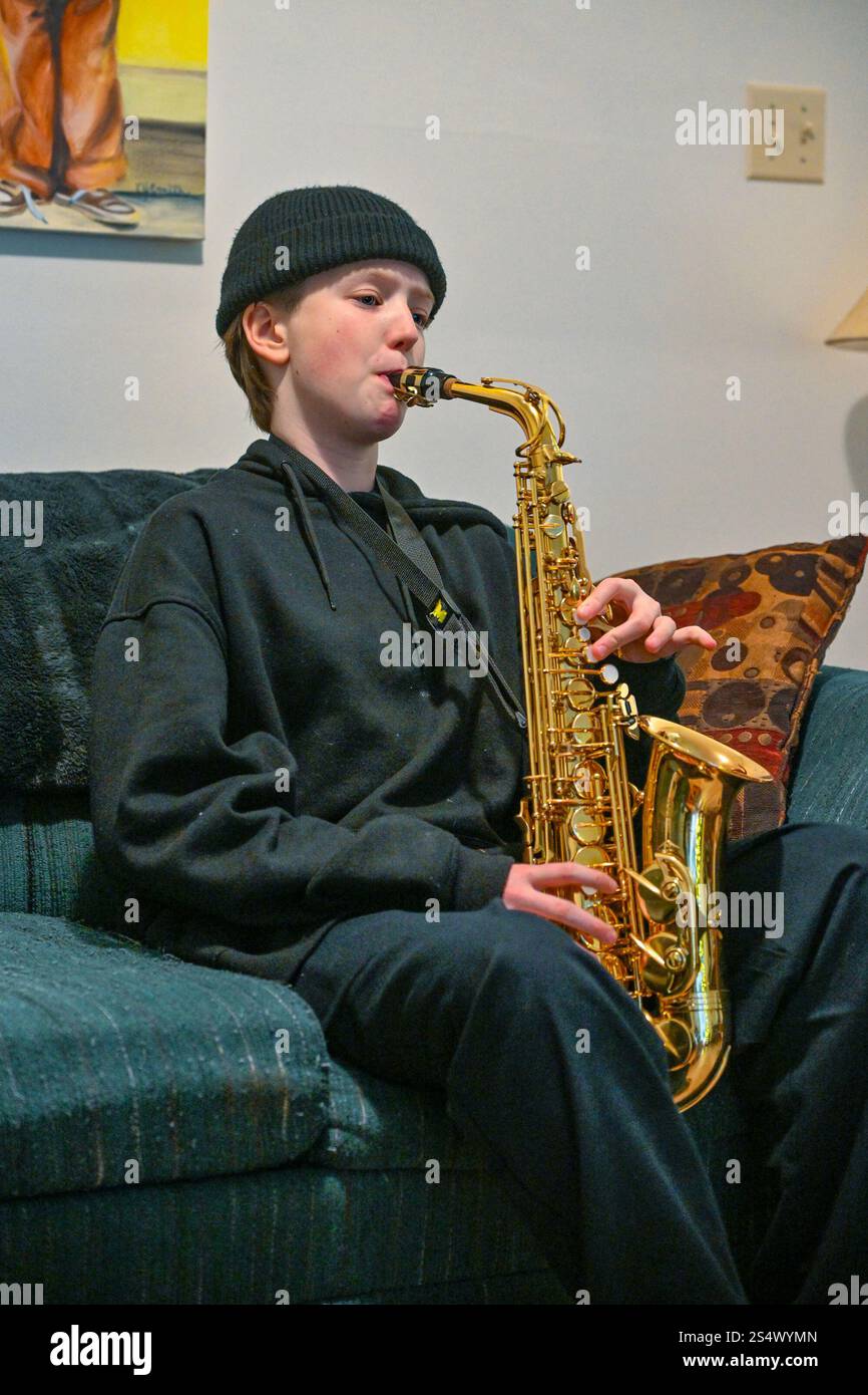 Young boy playing saxophone Stock Photo - Alamy