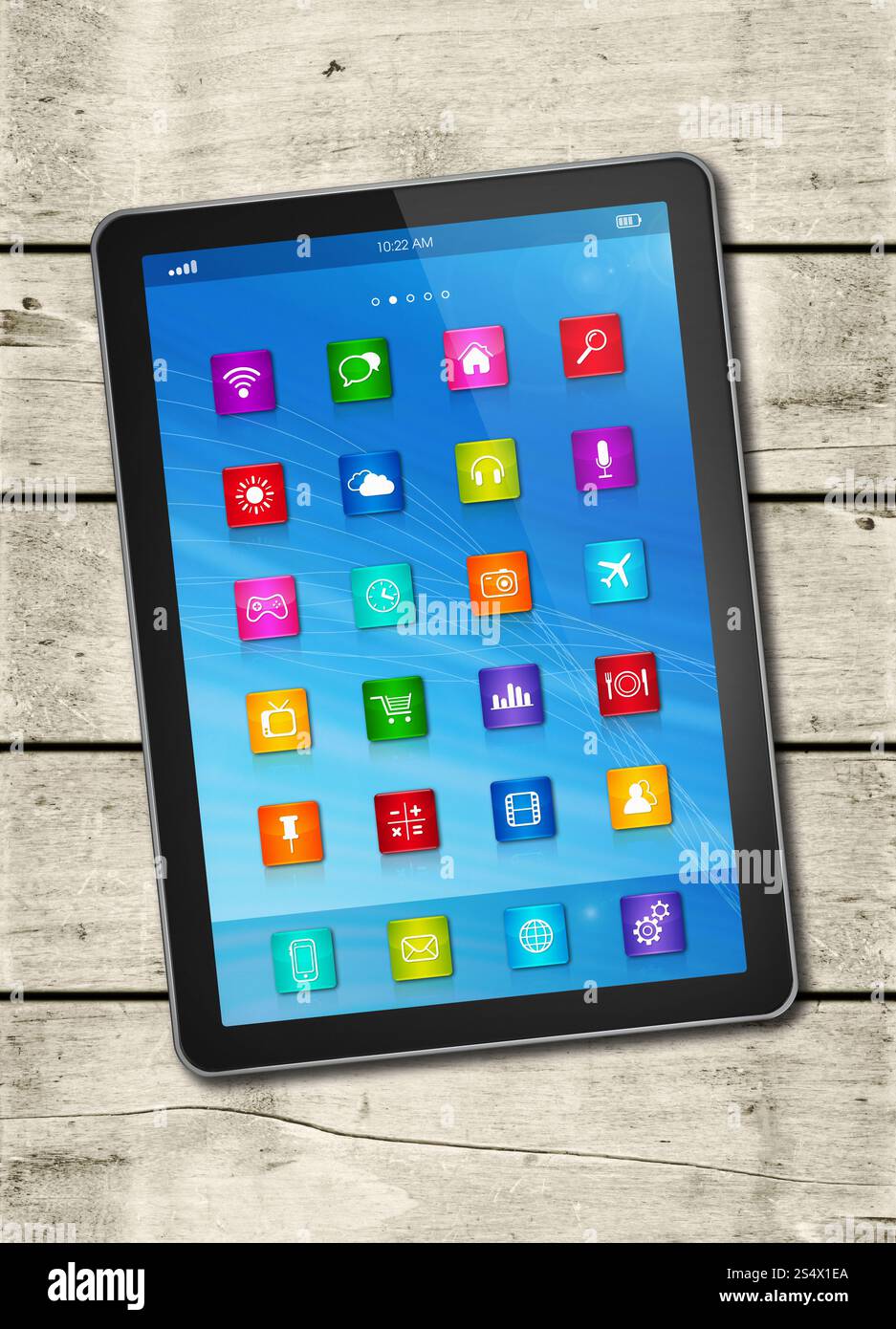 Digital tablet PC with desktop icons on a white wood table - vertical ...