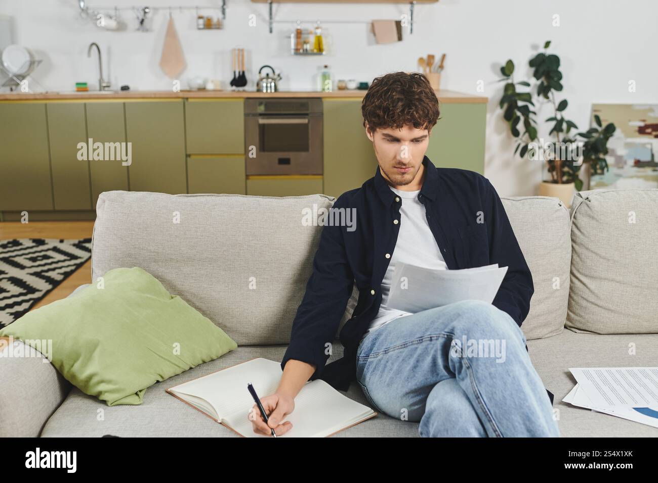 Handsome curly man writing notes hi-res stock photography and images ...