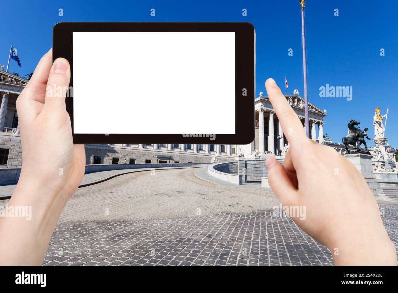 travel concept - tourist photographs Austrian Parliament Building in Vienna on tablet pc with ...