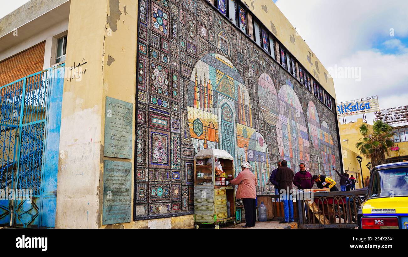 A vendor sells tea and snacks near a beautifully decorated wall mosaic ...