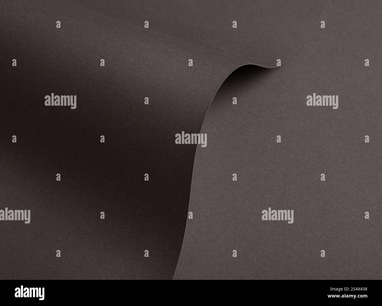 Charcoal gray paper background with curved, matte surfaces and a smooth ...