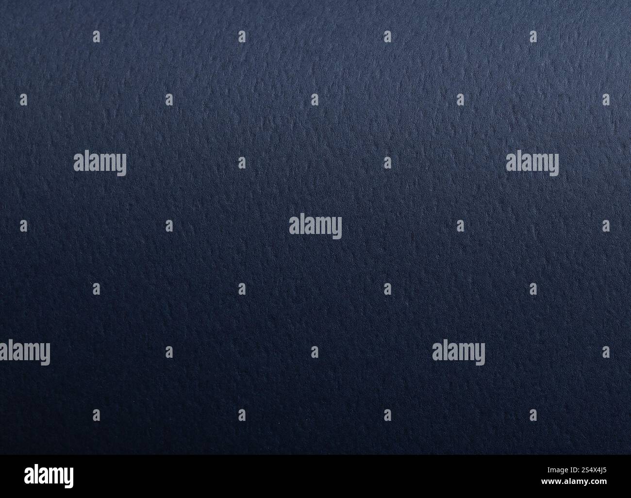 Dark navy blue paper background with a grainy matte texture and soft ...