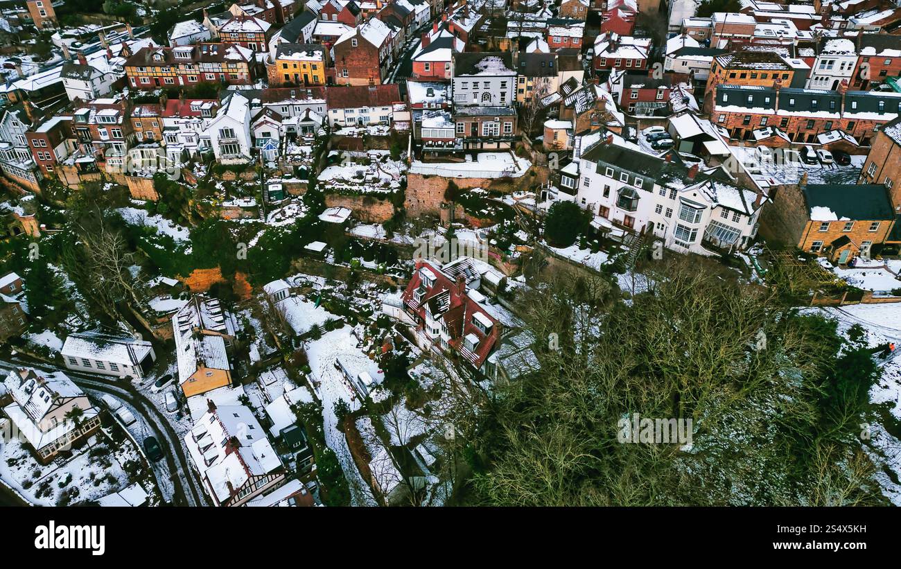 Aerial view of a snow-covered hillside residential area, featuring ...